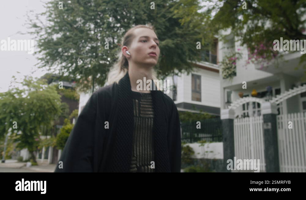 Stylish Caucasian Gen Z Male Model in Black Clothes Walking along ...