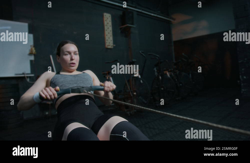 Female Athlete Doing Intense Upper Body Workout on Rowing Machine Stock Video Footage - Alamy