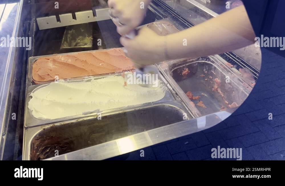 Hand Scooping Fresh Gelato Into A Cone At An Ice Cream Parlor Stock ...