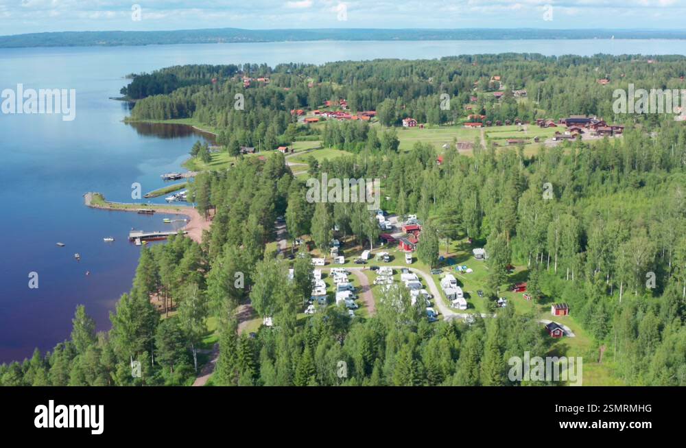Camping ground by lake in forest. Camp sight in aerial drone shot ...