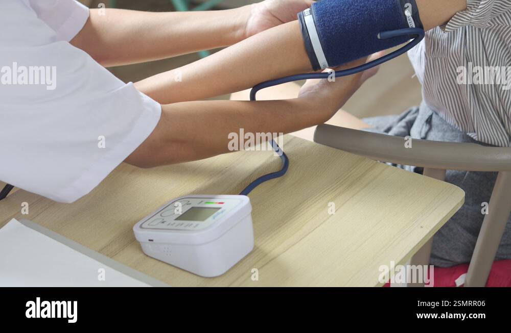 Doctor Put On Arterial Blood Pressure Cuff On Patient Arms In The ...