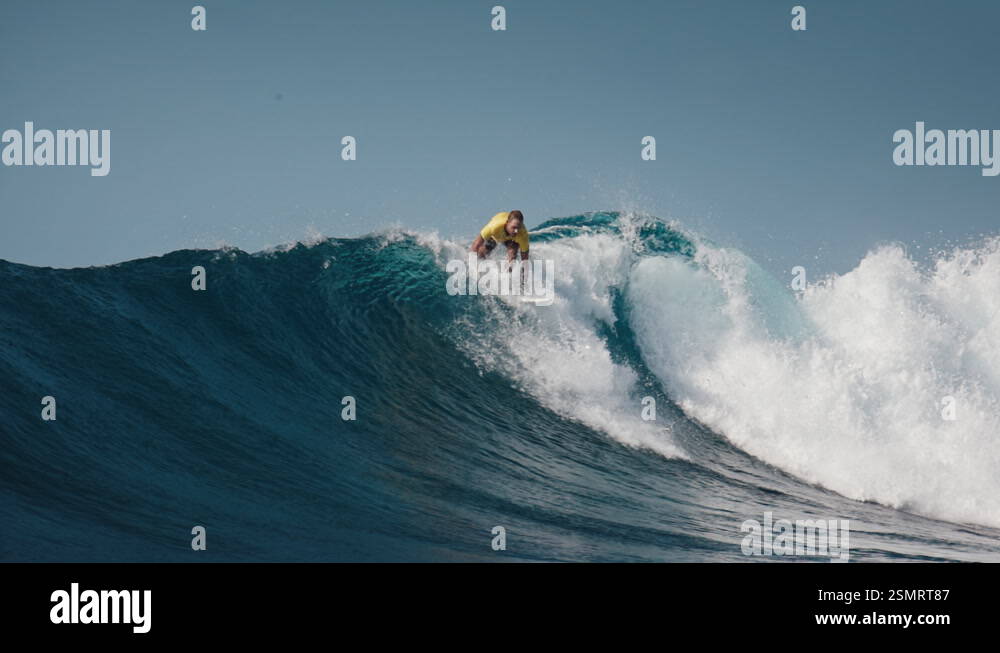 Male surfer takes off and falls into the foam. Surfing in the Maldives ...