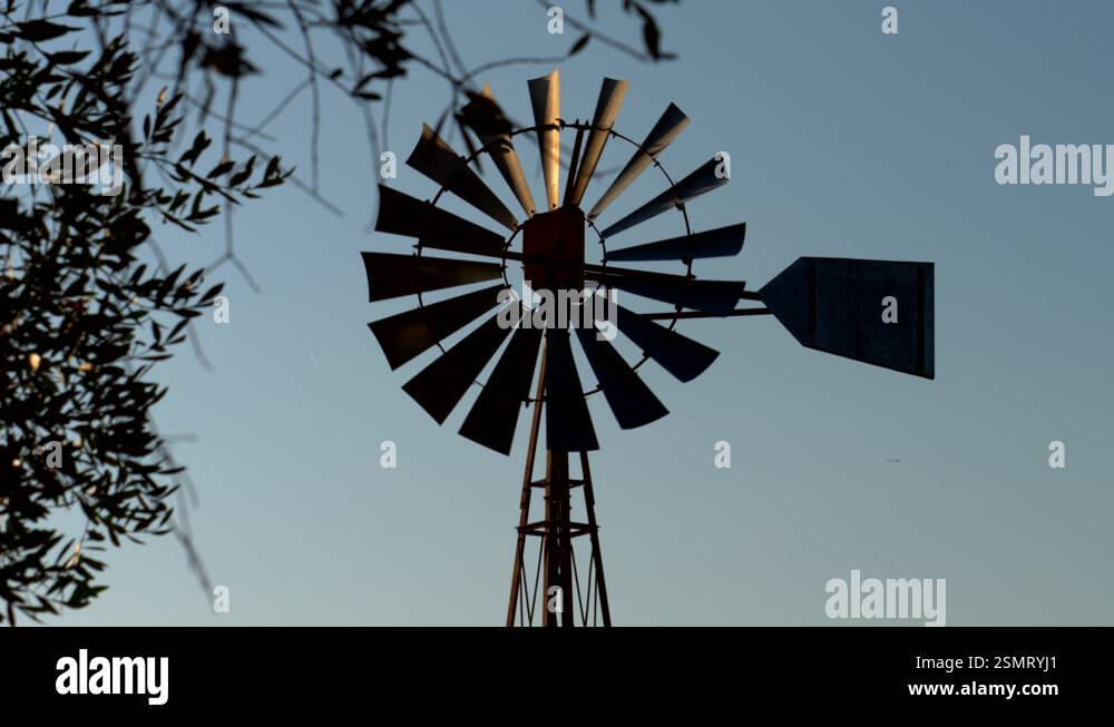 Metal windmill for pumping water wheel moved by the wind. Slow motion ...