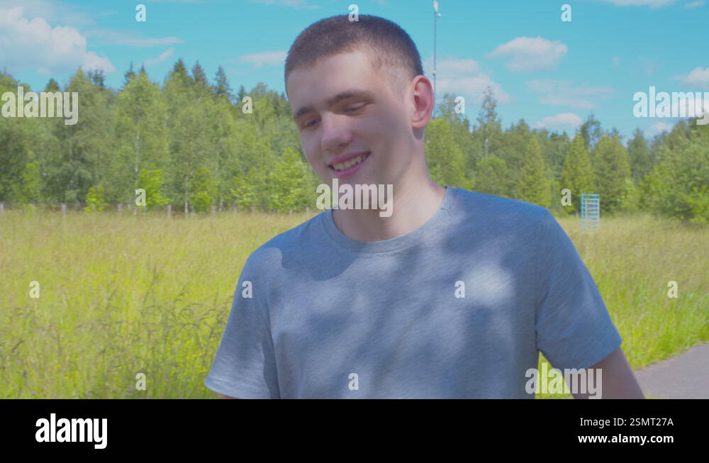 A slowly walking teenager talking while looking at the camera Stock ...