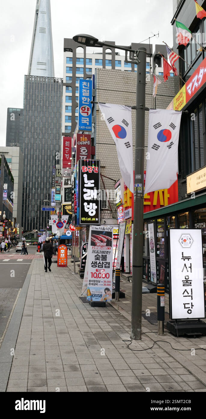 Bangi-dong dining district in Seoul, colorful signs and Korean flags ...