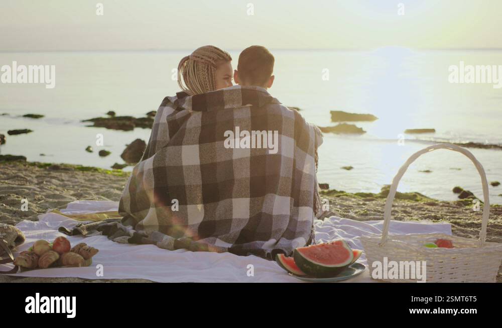 Imagine a Romantic Beach Picnic at Sunset where a Cozy Couple is ...