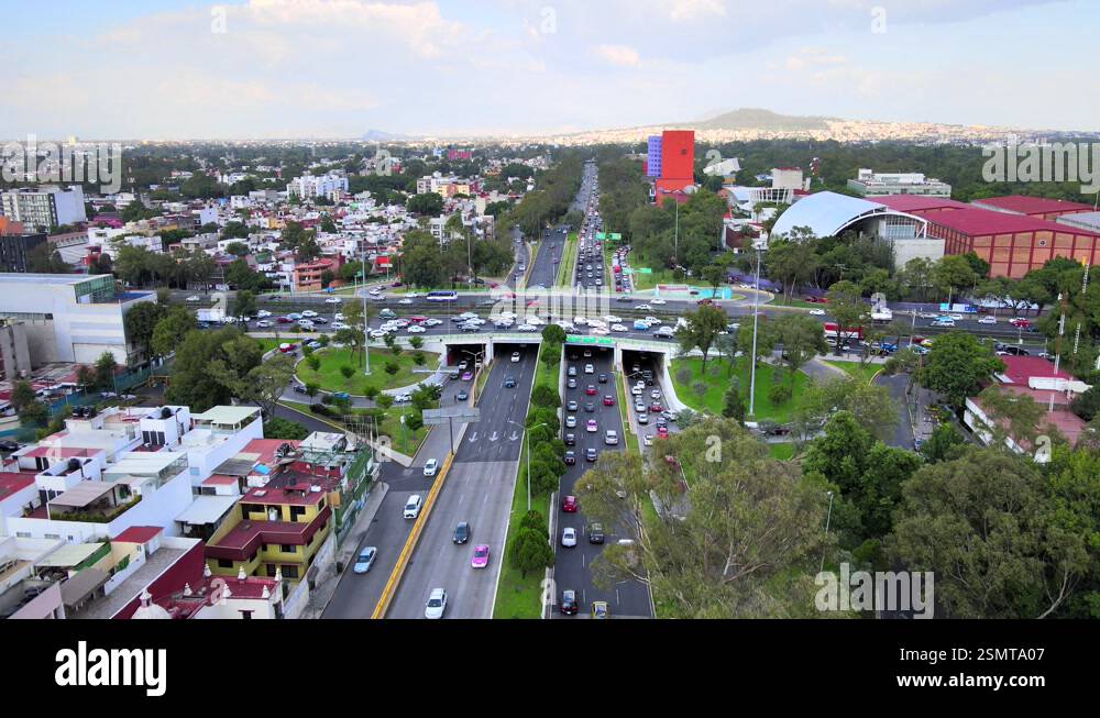 Traffic in the afternoon in Mexico City with the subway crossing the ...