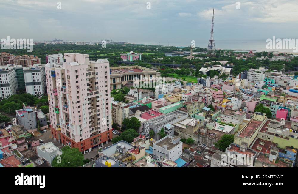 reveal shot of Kalaivanar Arangam auditorium with government hospital ...
