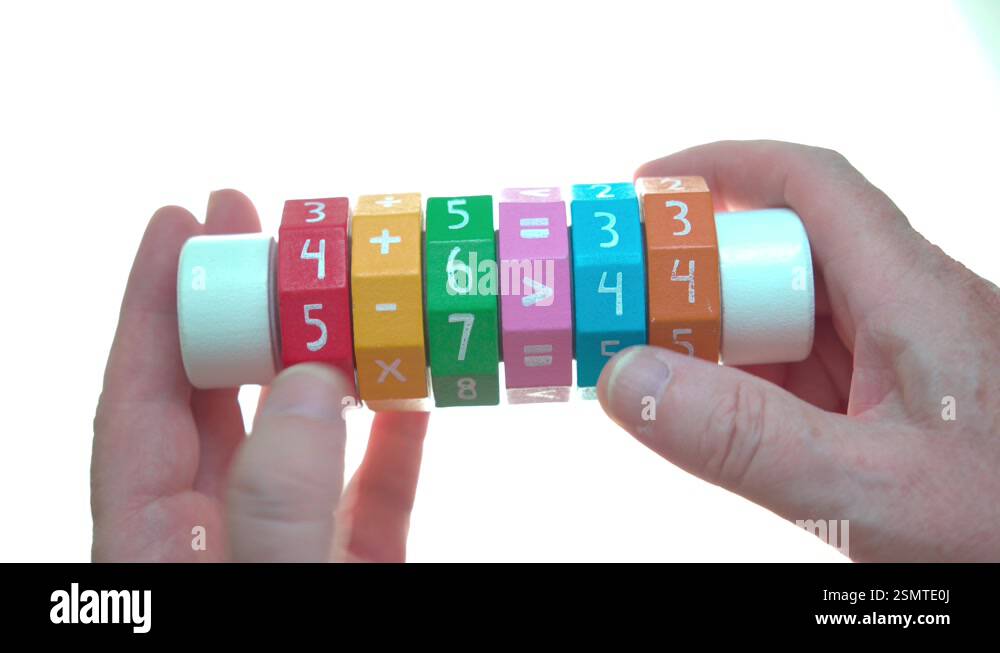 Hands holding a rotating math puzzle toy with numbers and symbols ...