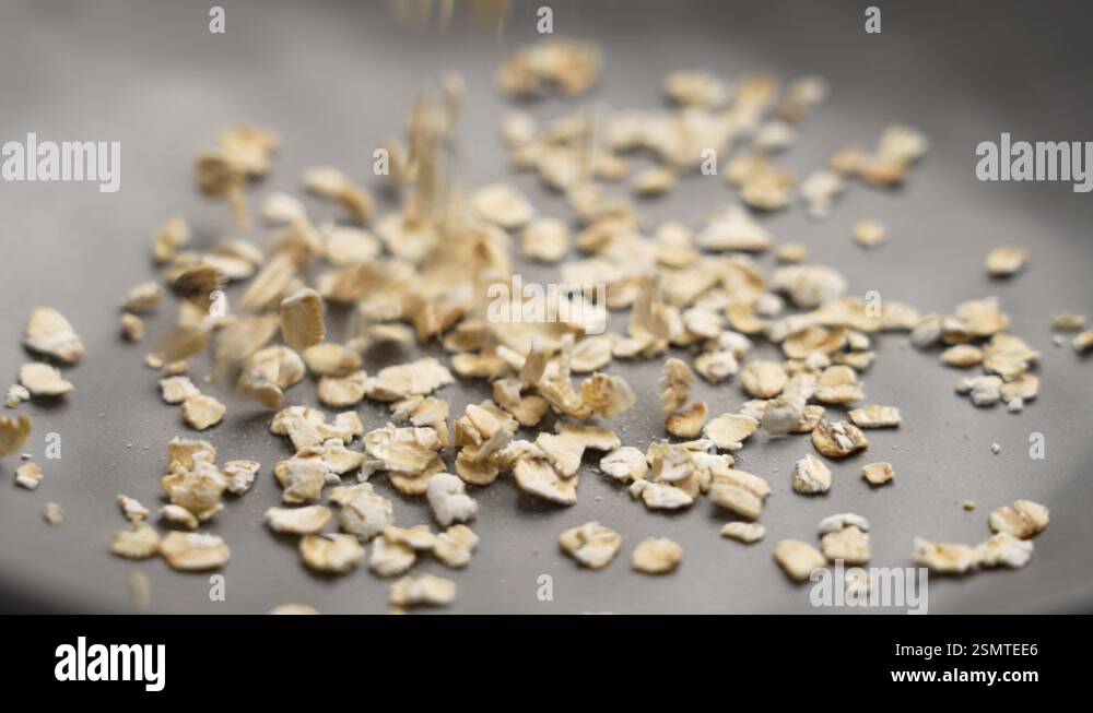 Organic oat cereal flakes falling into a kitchen bowl Stock Video ...