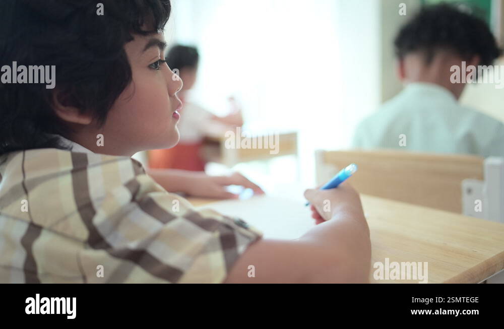 Students learn and study in a classroom of school where youngsters sit ...