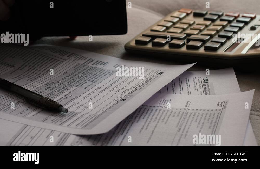 topic of payment and calculation of taxes by US citizens, male hand ...