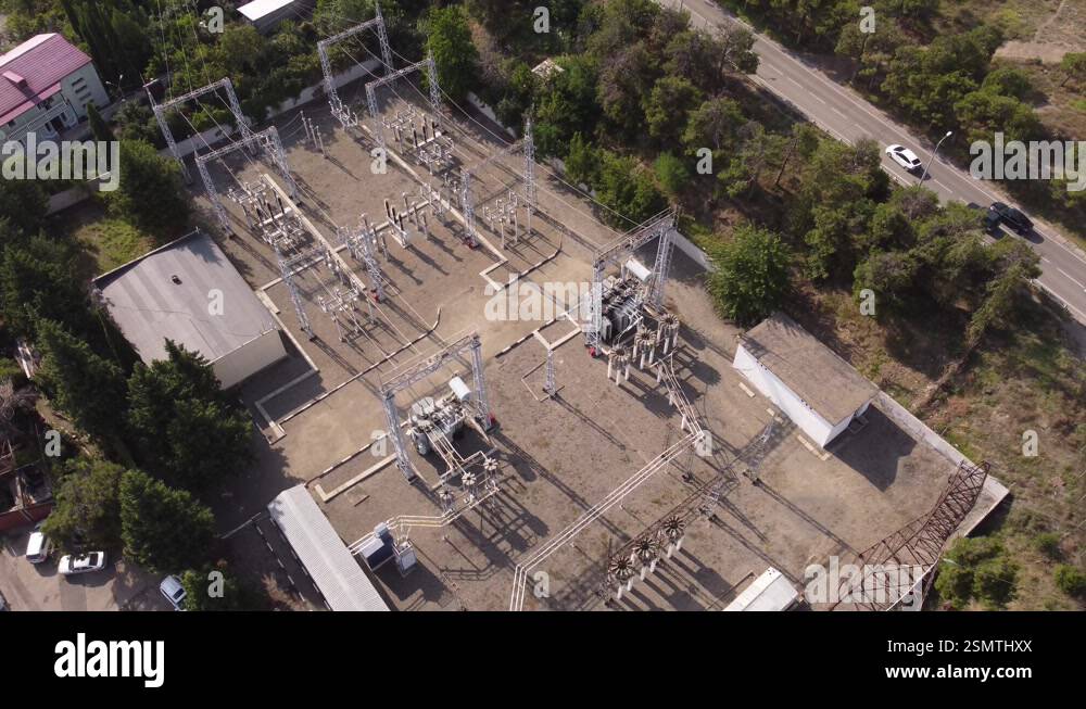 High voltage power substation by a busy roadside. Aerial view. Tbilisi ...