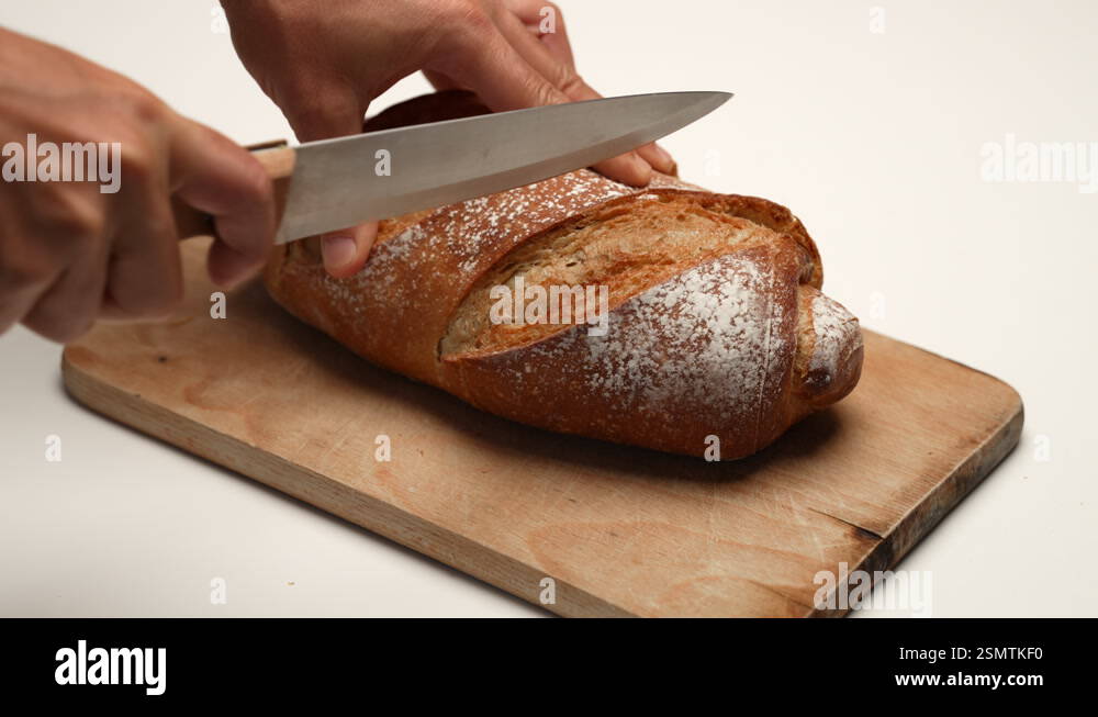 On a wooden breadboard, fresh, appetizing bread is placed alongside a ...