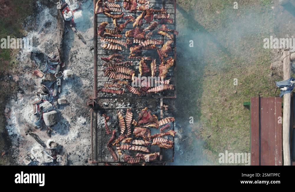 Top view of massive barbecue grill with variety of meats on it ...