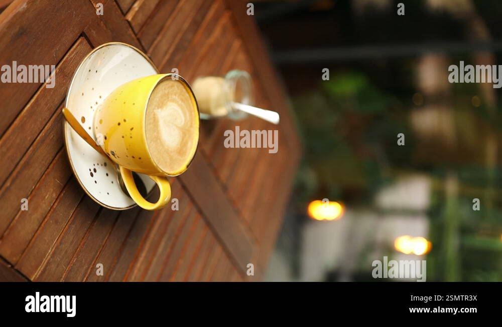 Yellow latte coffee cup with natural art. Hot coffee latte with latte ...