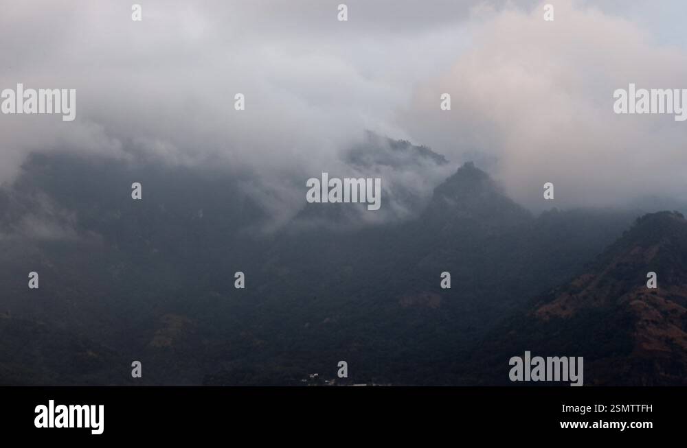 Fog moving time-lapse, active Atitlán volcano mountain peak valley ...