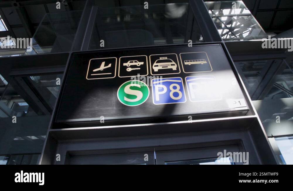 Airport directional sign showing symbols for various transport options ...