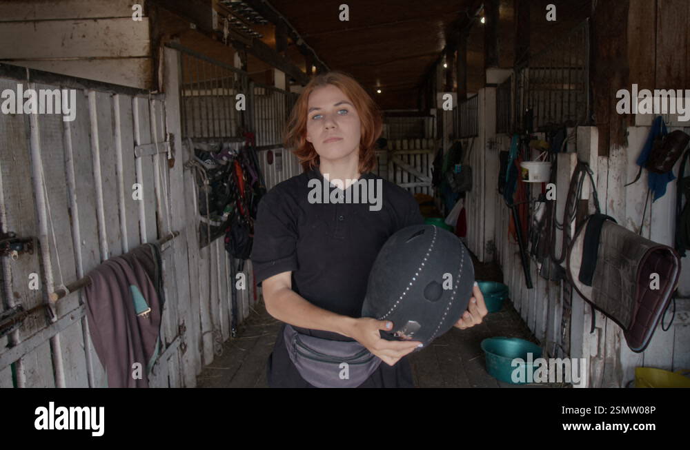 Female Rider Taking off Her Riding Helmet in Stall Stock Video Footage ...