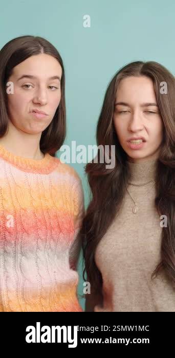 Two women display a range of confused and disgusted expressions ...