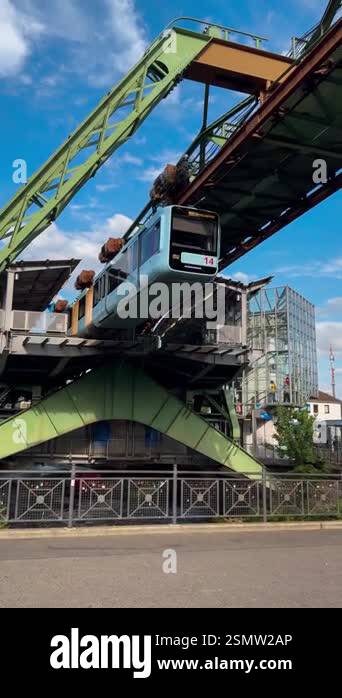 Train car moves on monorail suspended on overpass of Wuppertal ...