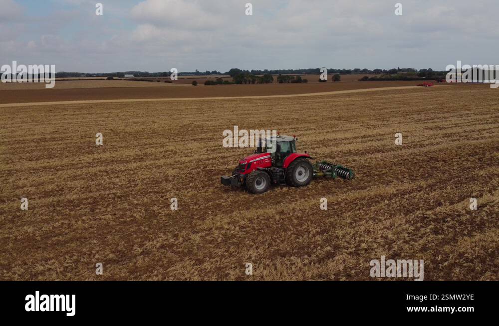 Drone. Red tractor soil tillage in a field. UK farming. Hull.UK 6.7. ...