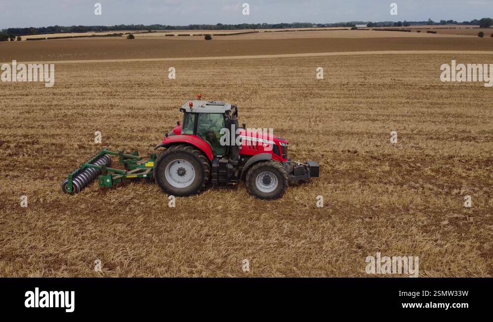 Drone. Red tractor soil tillage in a field. UK farming. Hull.UK 6.7. ...