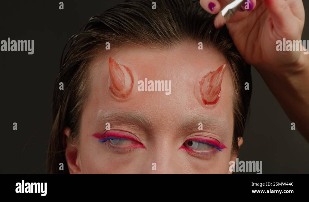 Halloween concept. Demon devil woman with white eyes red face and small ...