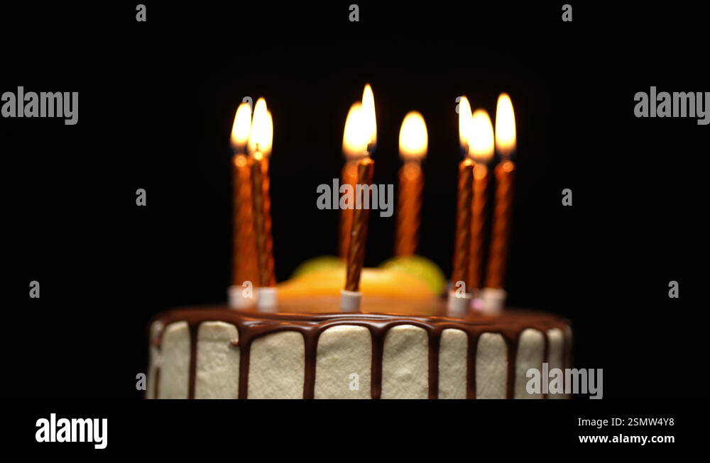 Birthday cake with lit candles, as the camera slowly pulls back to ...
