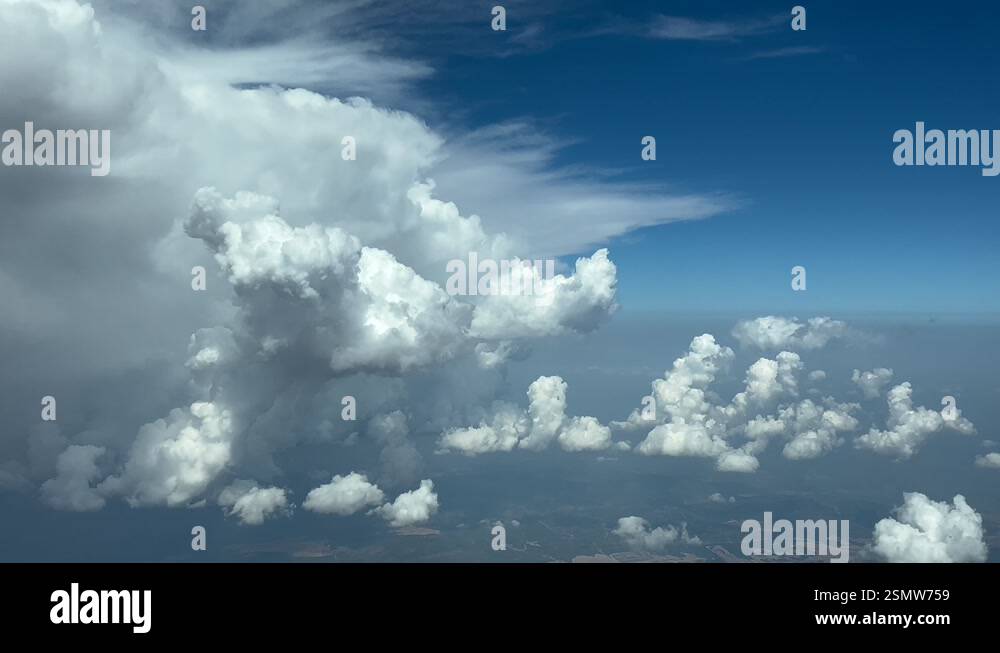 Immersive POV flying in a blue sky with a huge storm cumulonimbus cloud ...