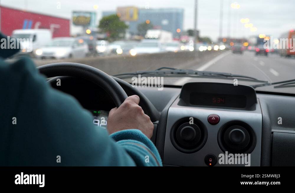 A driver navigates through busy highway traffic during the early ...
