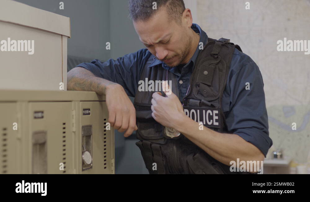 Zoom out police officer praying in locker room before shift Stock Video ...