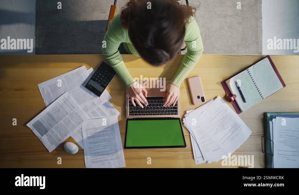 Accountant working mockup laptop top view. Woman examining documents ...