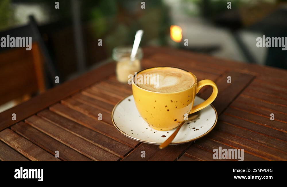 Yellow latte coffee cup with natural art. Hot coffee latte with latte ...