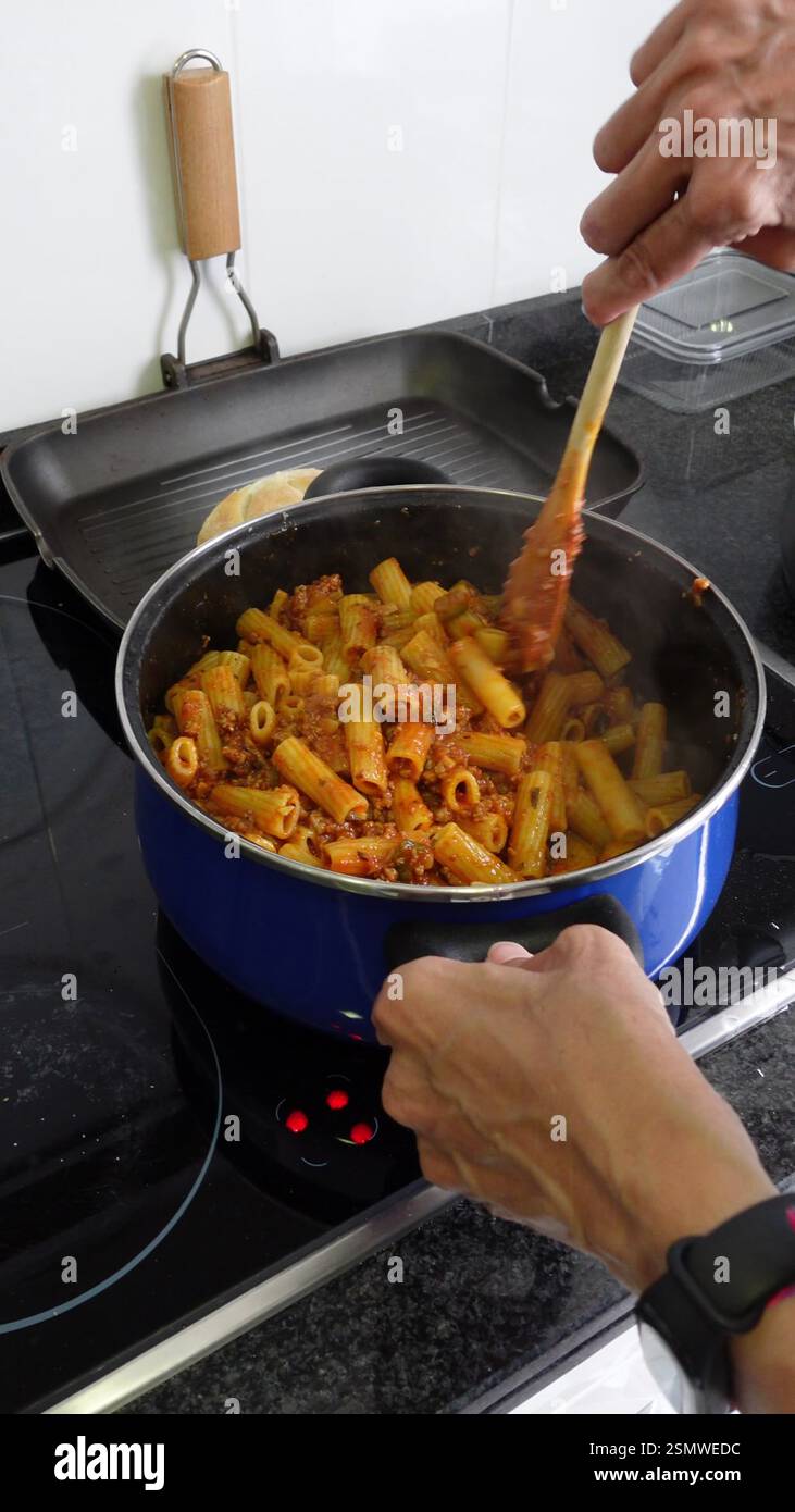 Vertical shot of mixing macaroni with bolognese sauce Stock Video ...