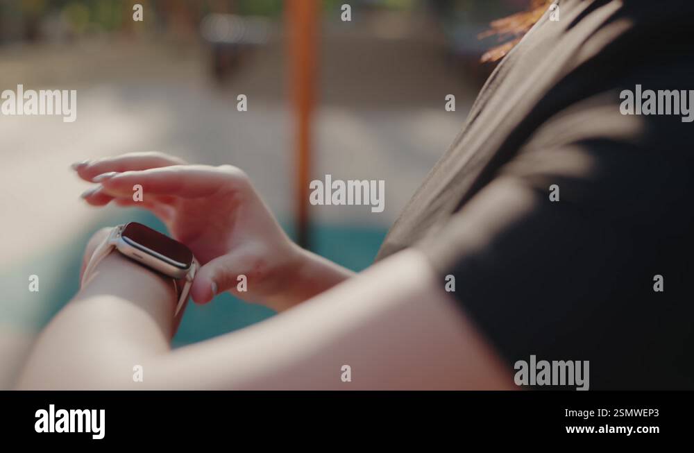 Close-Up of Woman Adjusting Smartwatch During Outdoor Exercise Stock ...