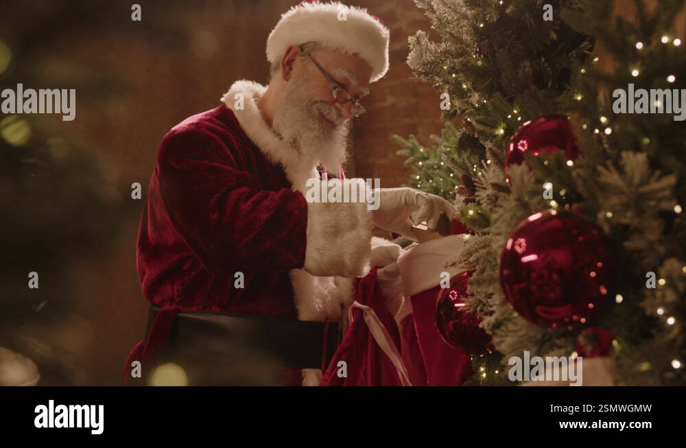Santa Discreetly Filling Christmas Stockings with Treats and Gifts ...