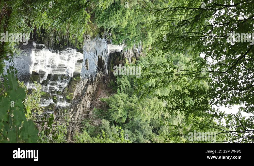 Vertical wide-angle shot of the beautiful Falls of Clyde with water ...