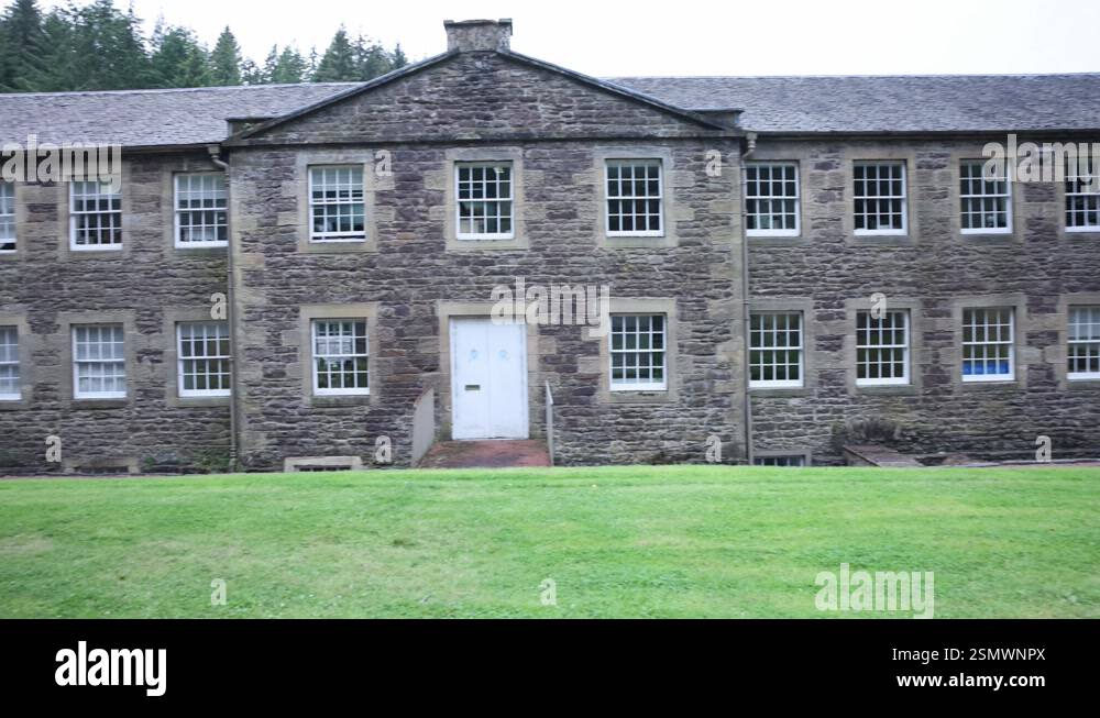 Slow panning shot of antique buildings at the UNESCO site in New lanark ...