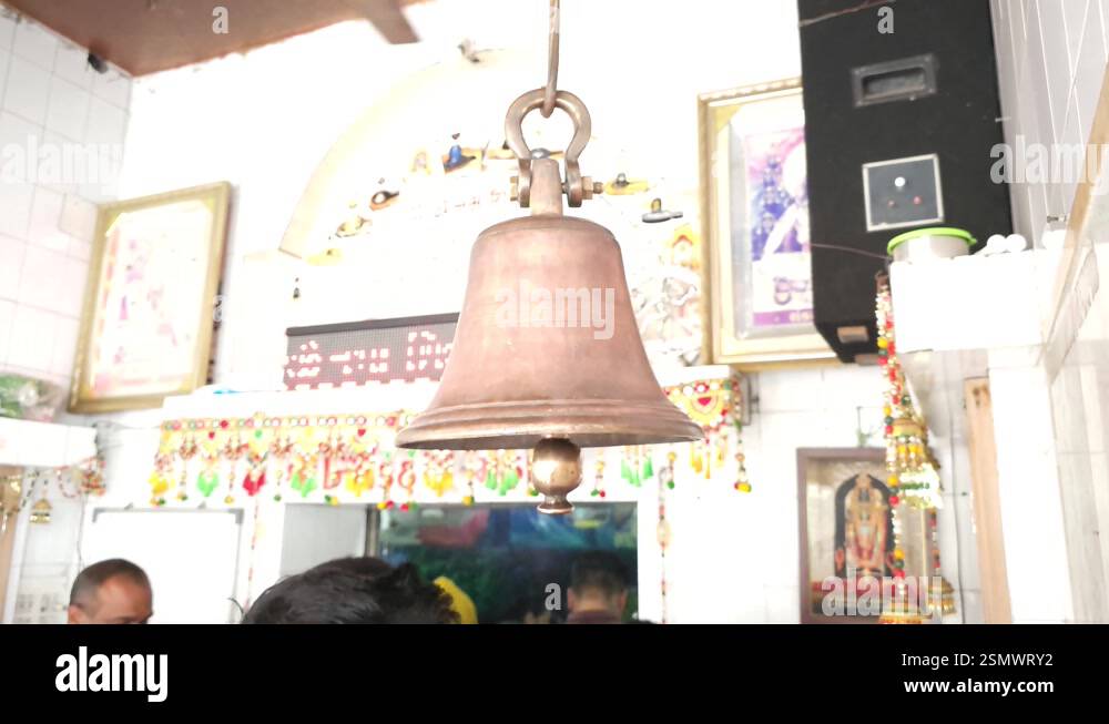 Hindu Rituals, people are religiously ringing bell in temple Stock ...