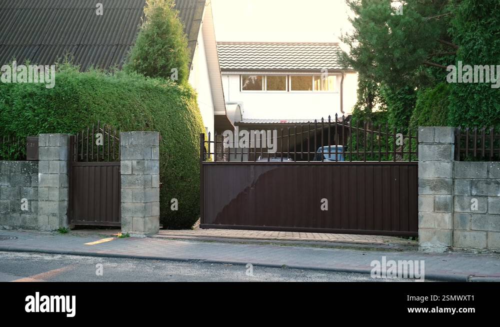Opening of automatic entrance gate of brown color made of metal. Block ...