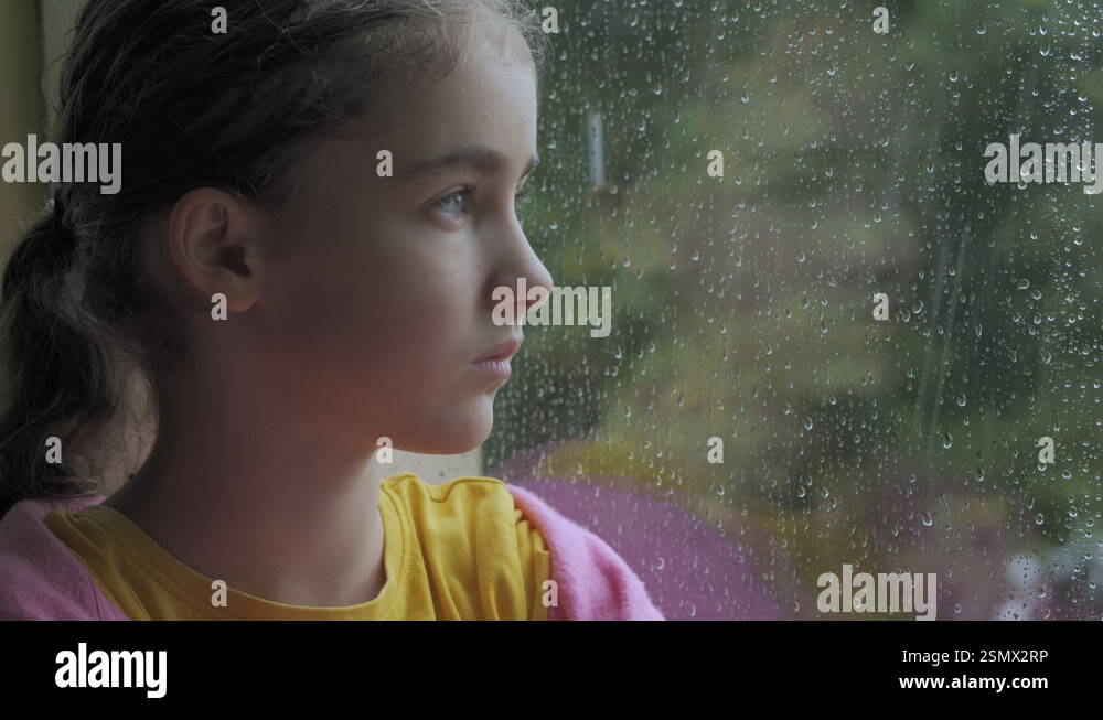 Alone Sad Little Girl Depressed by Bad Weather Watching Rain Through ...