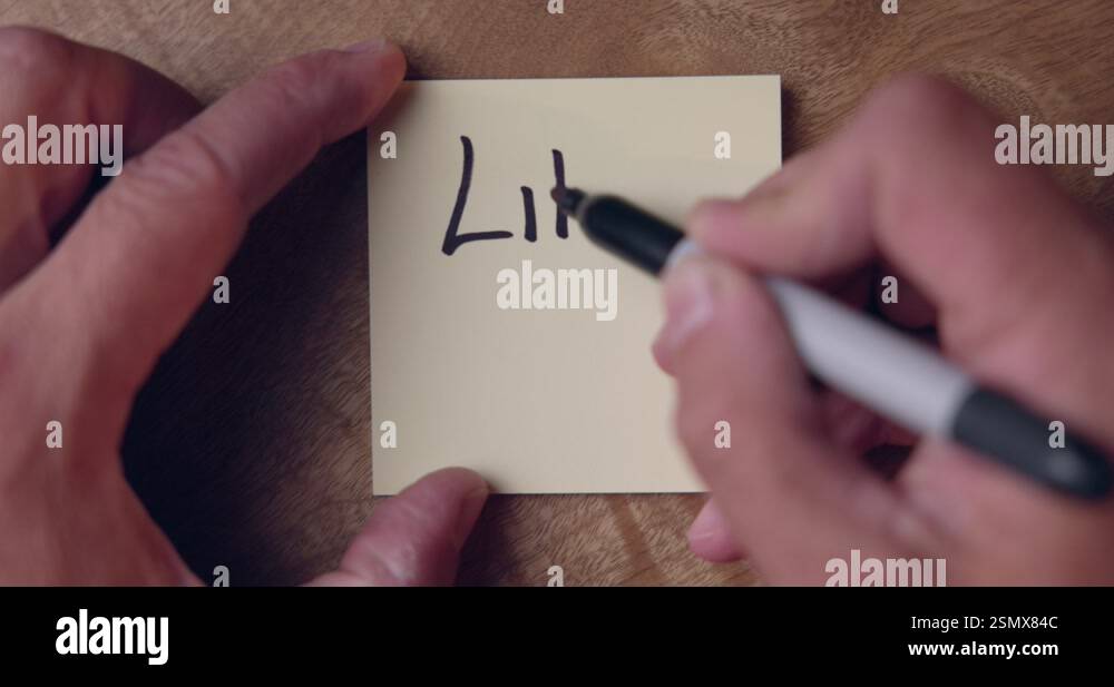 A person is writing Like and Subscribe on a sticky note on a desk Stock ...