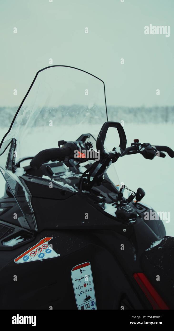 Snowmobile handle bars on frozen lake in winter in Rovaniemi, Lapland ...