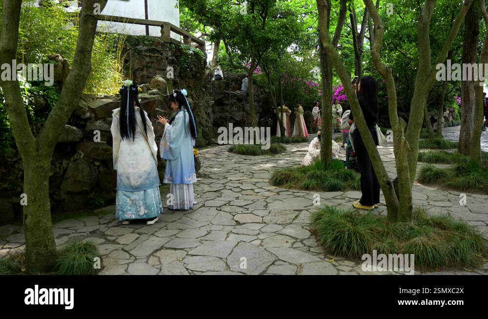Suzhou, China - 04/22/2024: Women in traditional Hanfu clothing in a ...