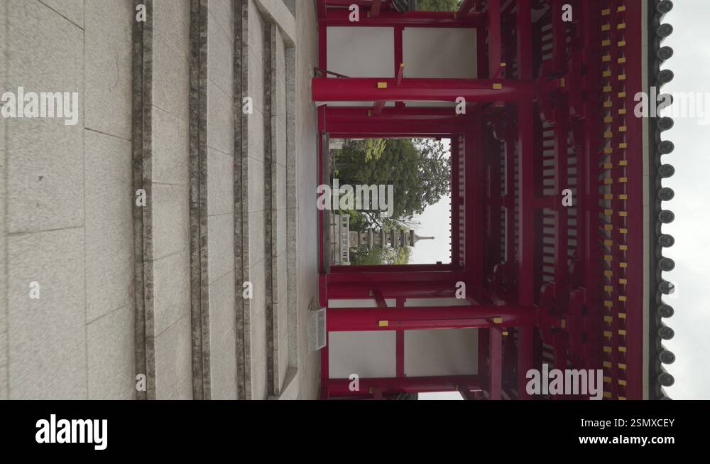 A vertical shot approaching the red entrance gate into a Japanese ...