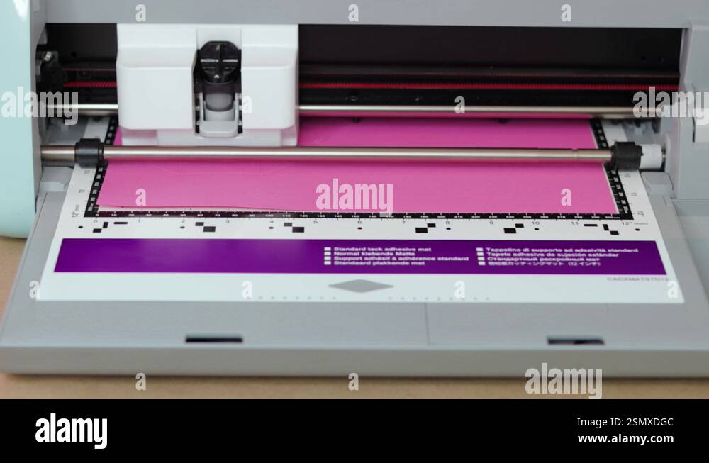 Cutting plotter processing vibrant pink cardboard with precision Stock ...