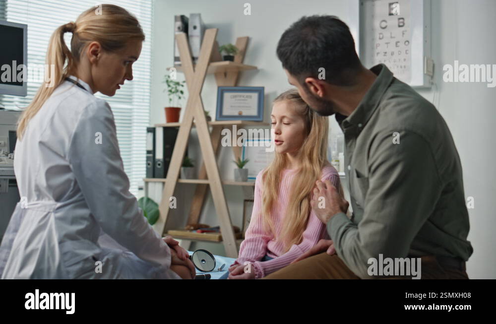 Child doctor consulting family in modern clinic. Father visiting ...