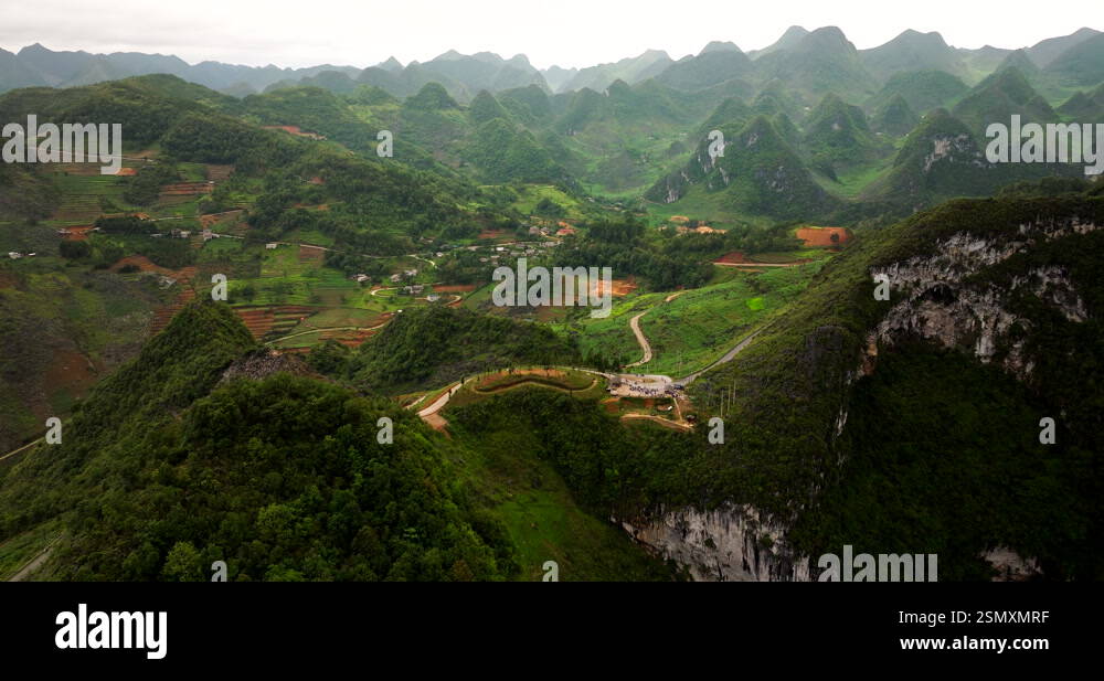 High above Ha Giang Loop’s embrace, where winding roads twist with ...