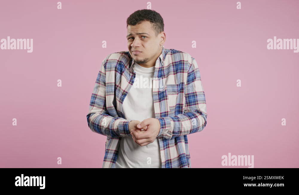 Confused biracial man, shoulders up - can't help, makes gesture of I ...